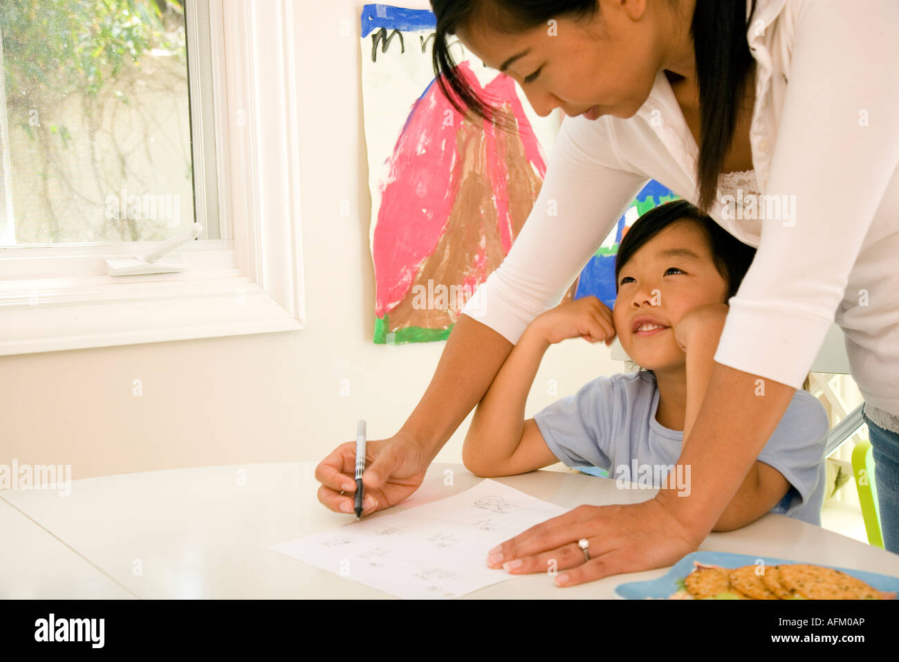 Mom Helping Son with his Homework Stock Photo - Alamy