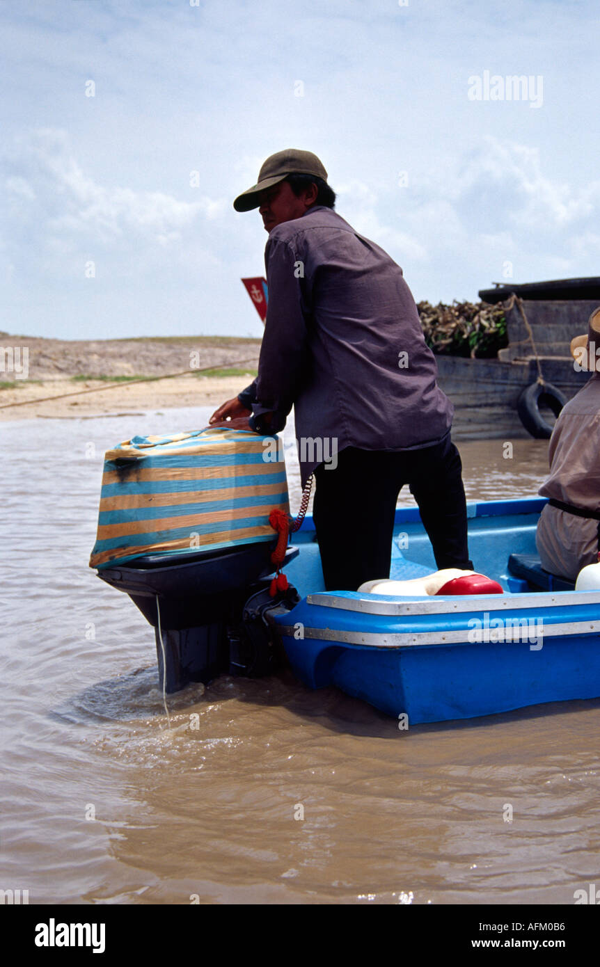 Boat driver on canal journey Takeo to Angkor Borei Cambodia Stock Photo ...