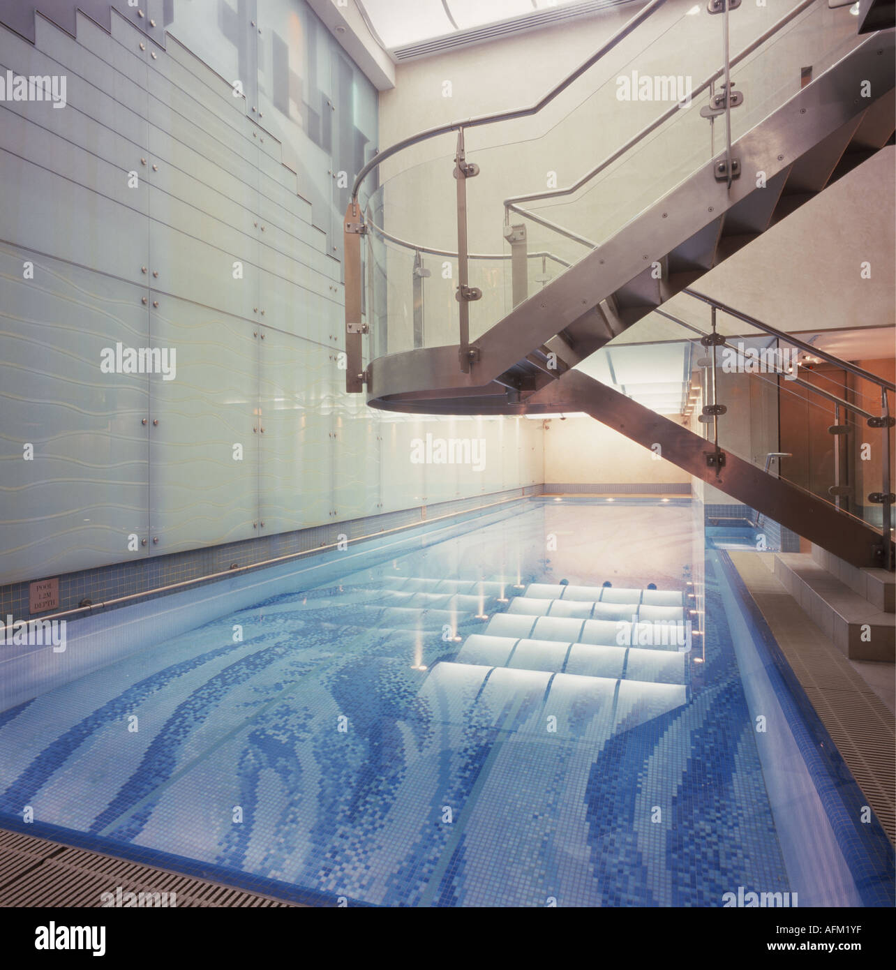 Glass and steel cantilevered staircase in modern hotel indoor swimming ...