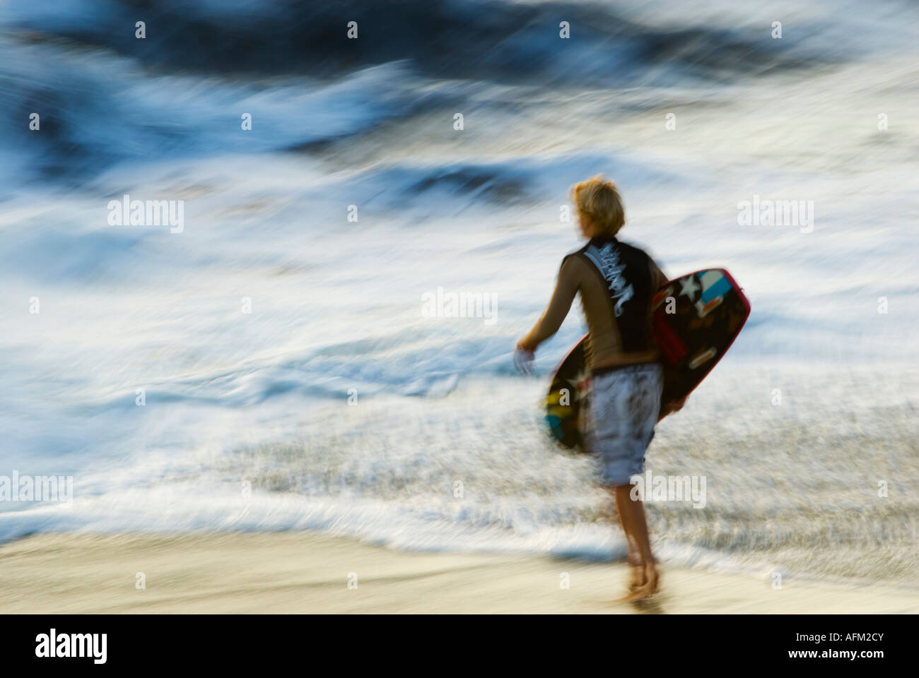 Surfer about to get into the water Stock Photo - Alamy