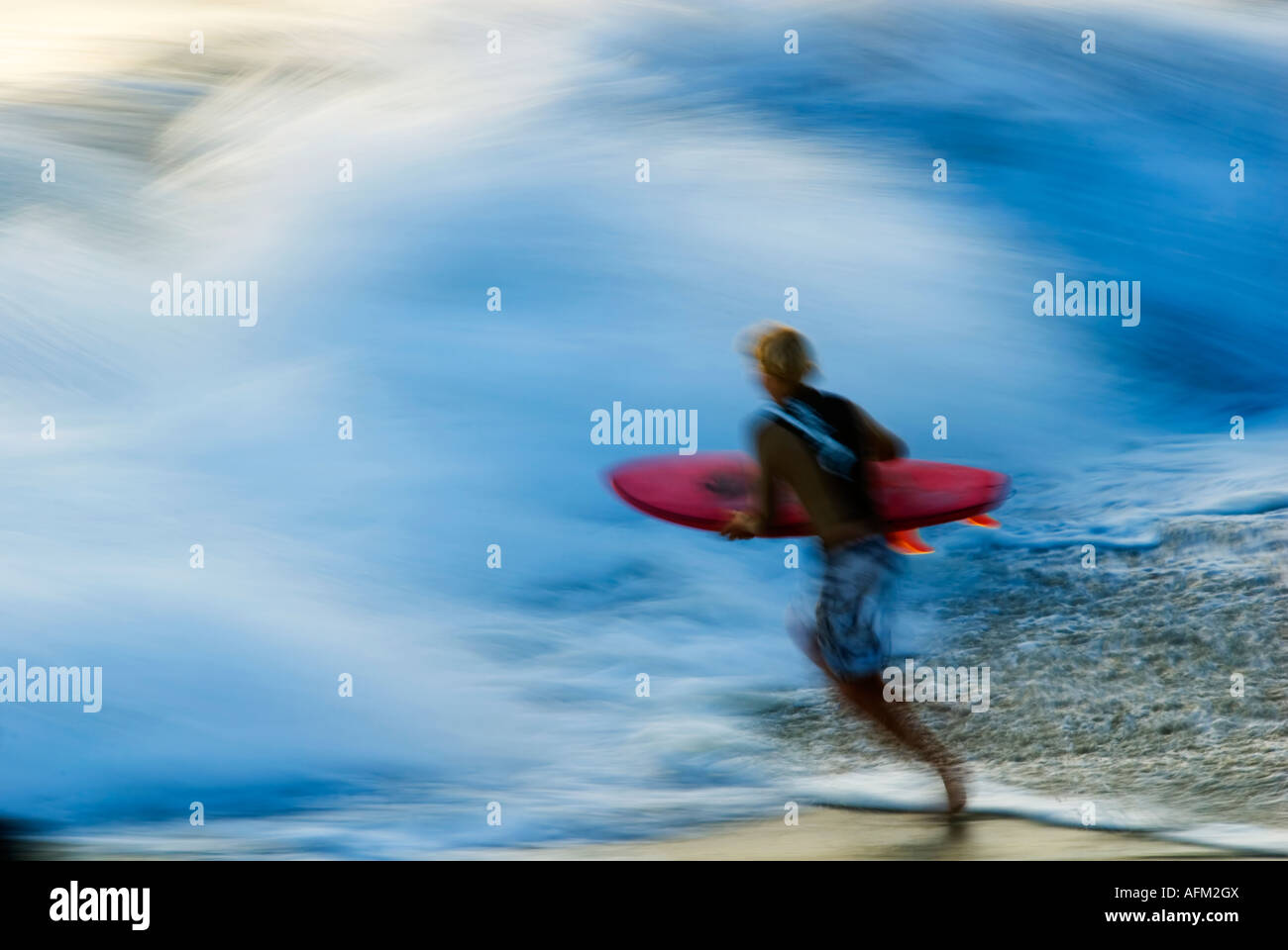 Surfer about to get into the water Stock Photo - Alamy
