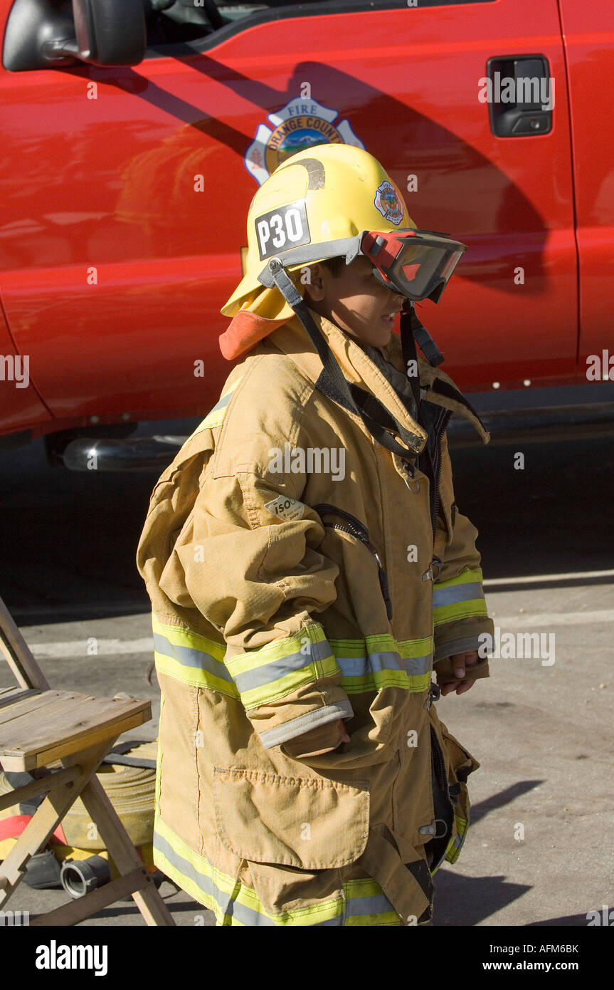A boy takes the opportunity to dress up in firefighter equipment Stock ...