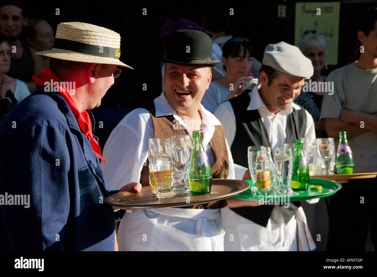 3 waiters taking part in a race, dressed in 1900 period costume Stock ...