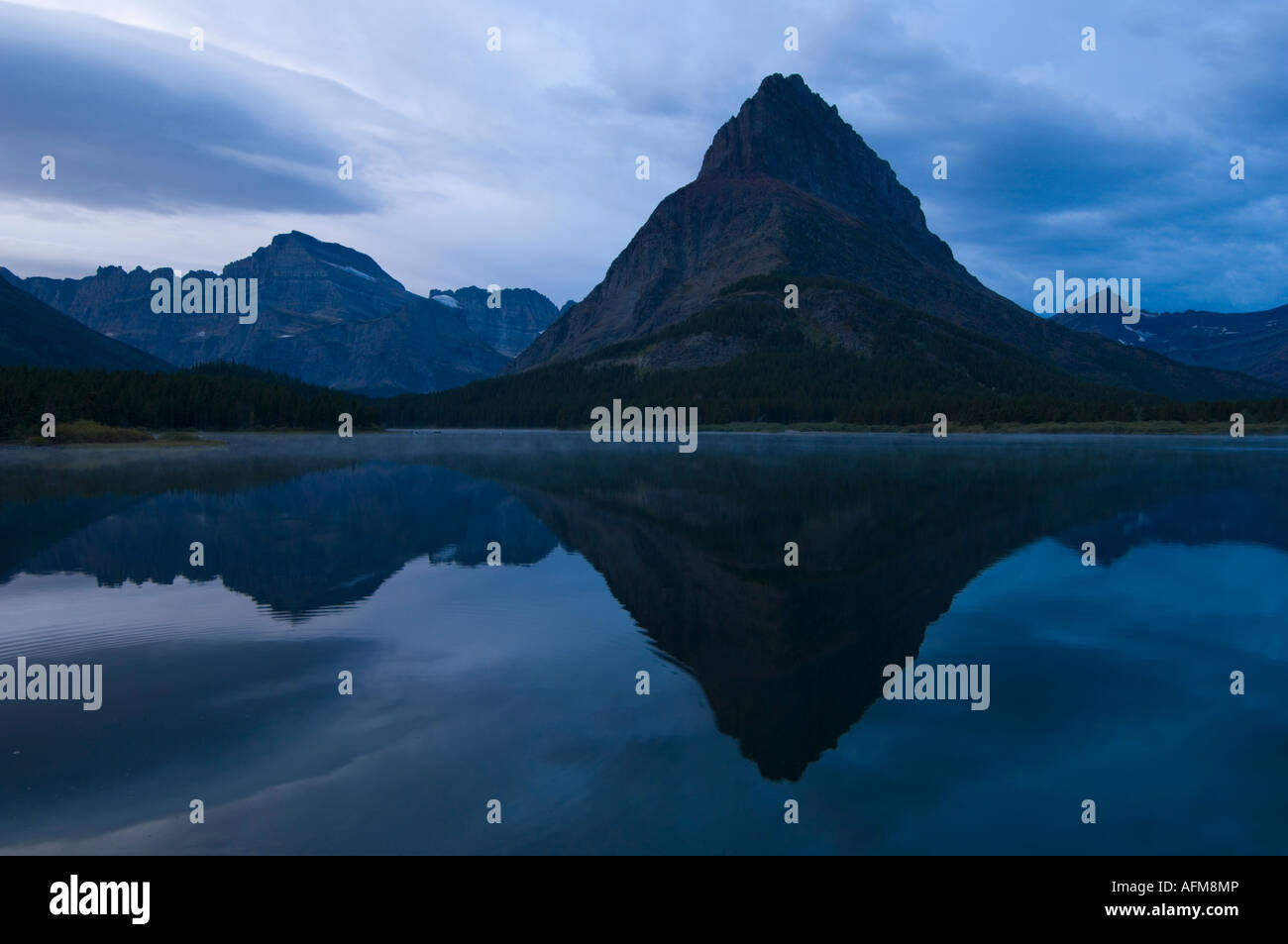 Pre dawn blue over Swiftcurrent Lake Glacier National Park Montana USA ...