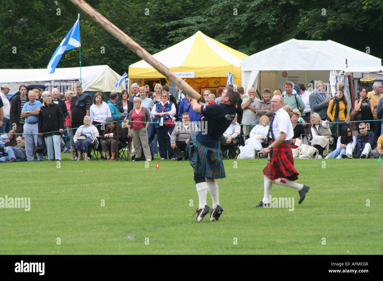 Scottish man in kilt tossing the caber at scottish highland games ...