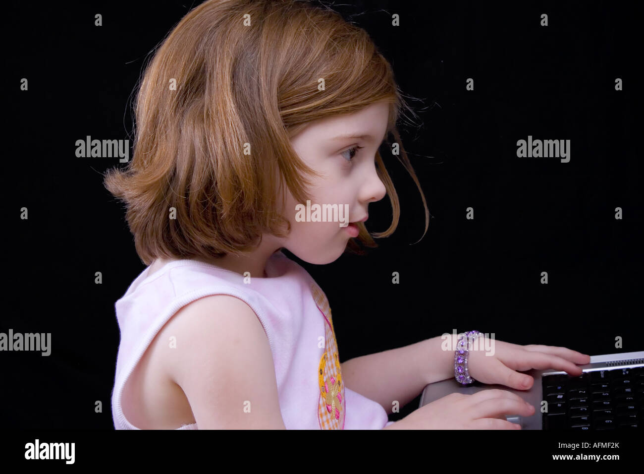 Cute little redheaded girl using a computer Stock Photo - Alamy