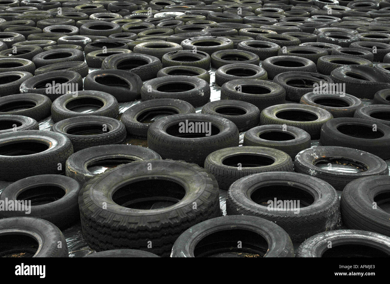 Old tires covering black plastic sheet over silage Stock Photo - Alamy