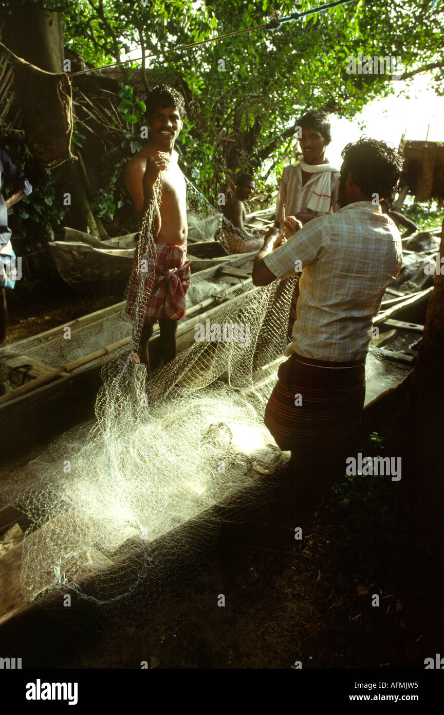 India Kerala Cochin Bolgatty Island fishing fishermen mending nets ...