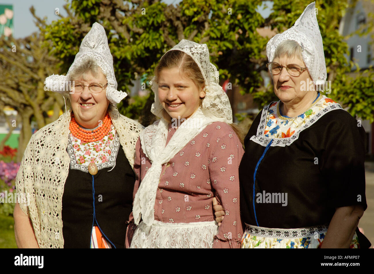 Three Dutch ladies in period costumes pose at the tulip Festival in ...