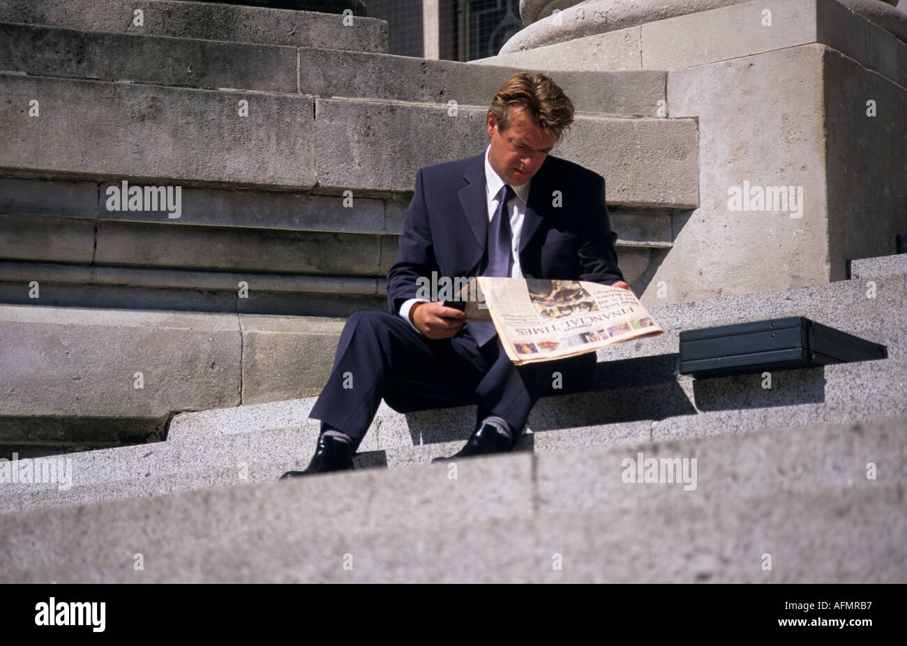Reading the times hi-res stock photography and images - Alamy