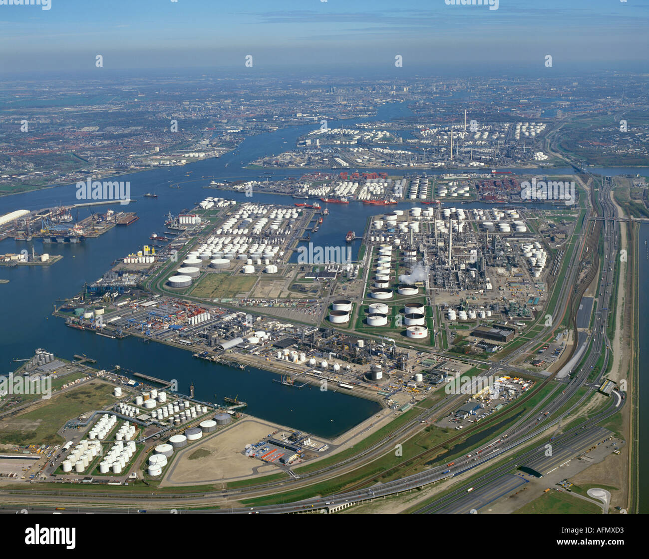 Aerial view of the harbour of Rotterdam with oil refinery storage tanks ...