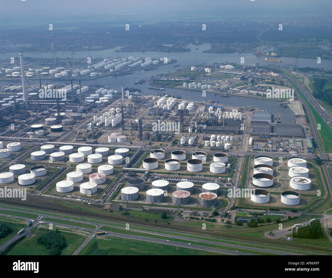 Aerial view of the harbour of Rotterdam with oil refinery storage tanks ...
