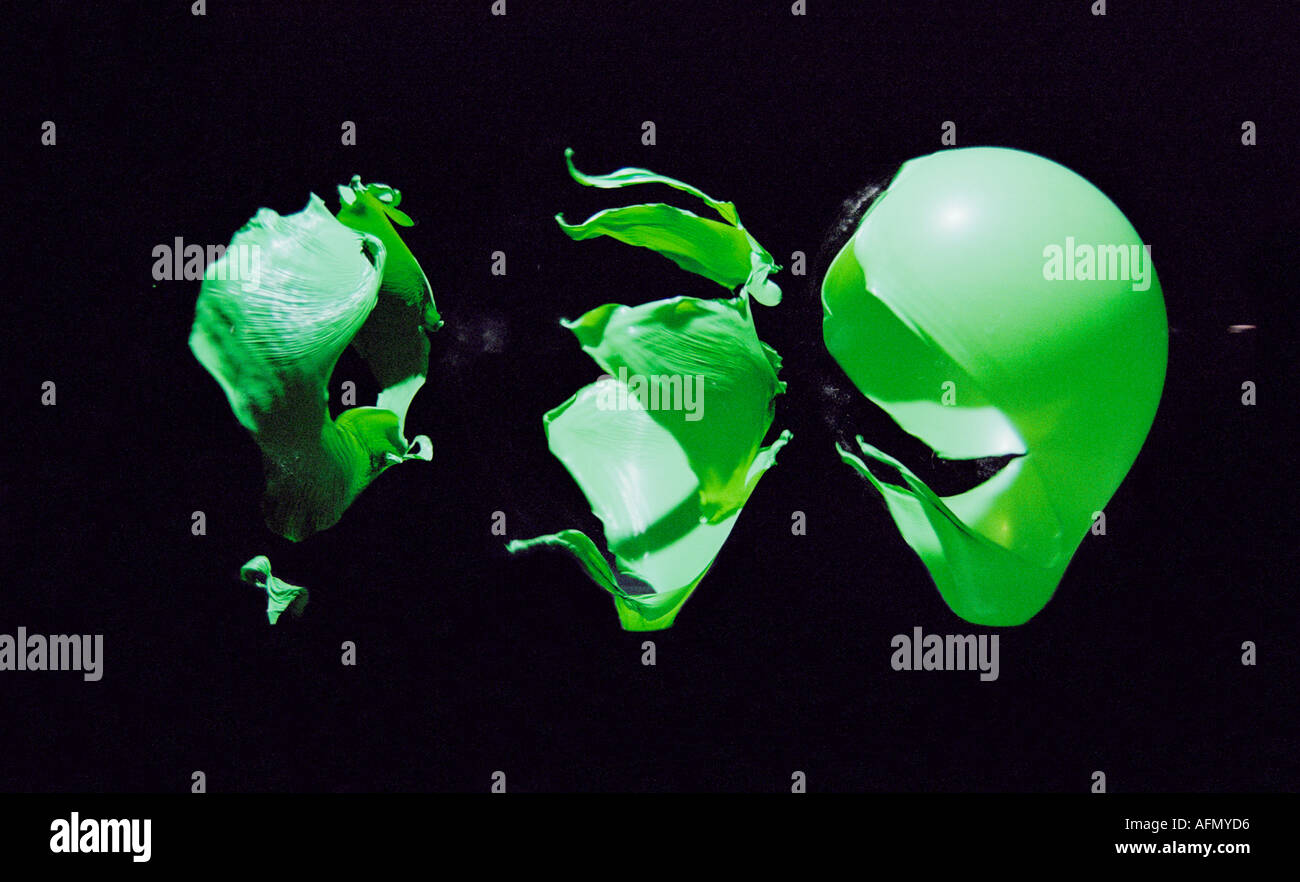 High speed photography showing three green balloons being burst by a 22 ...