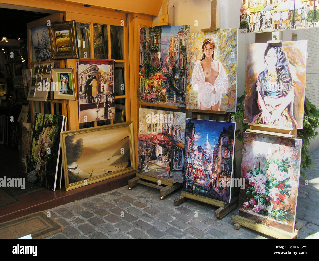 Display of paintings outside gallery shop near Place du Tertre ...