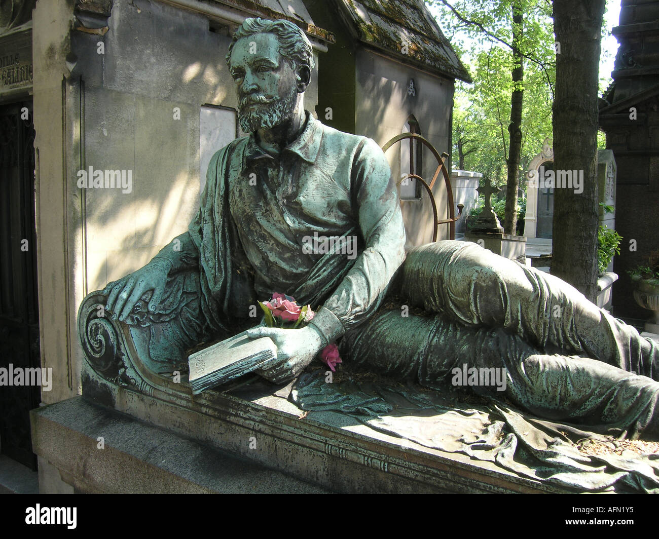 Architectural detail of crypt with human figure and pink rose at Pere ...