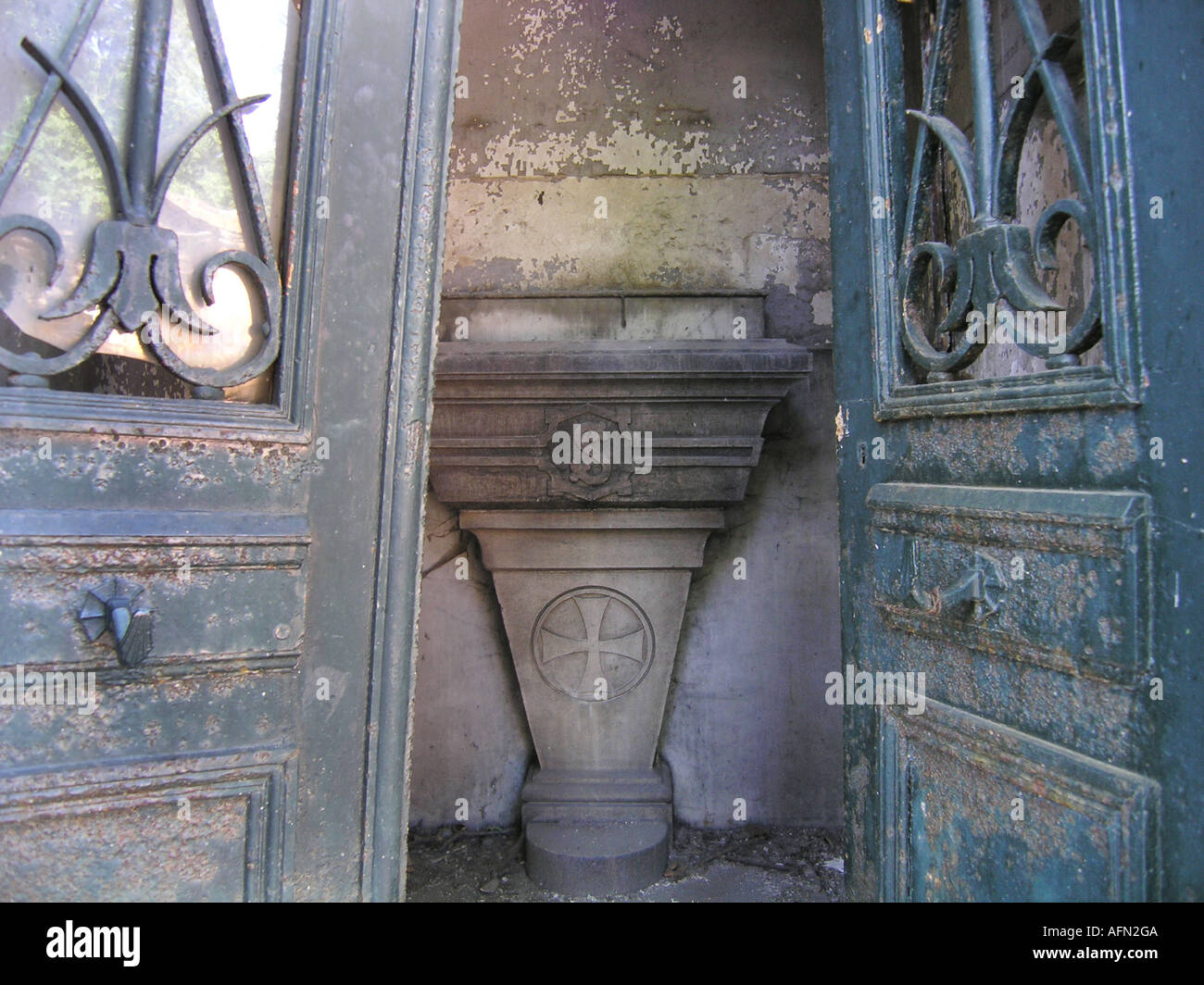 mysterious derelict crypt with open blue door at Pere Lachaise cemetery ...