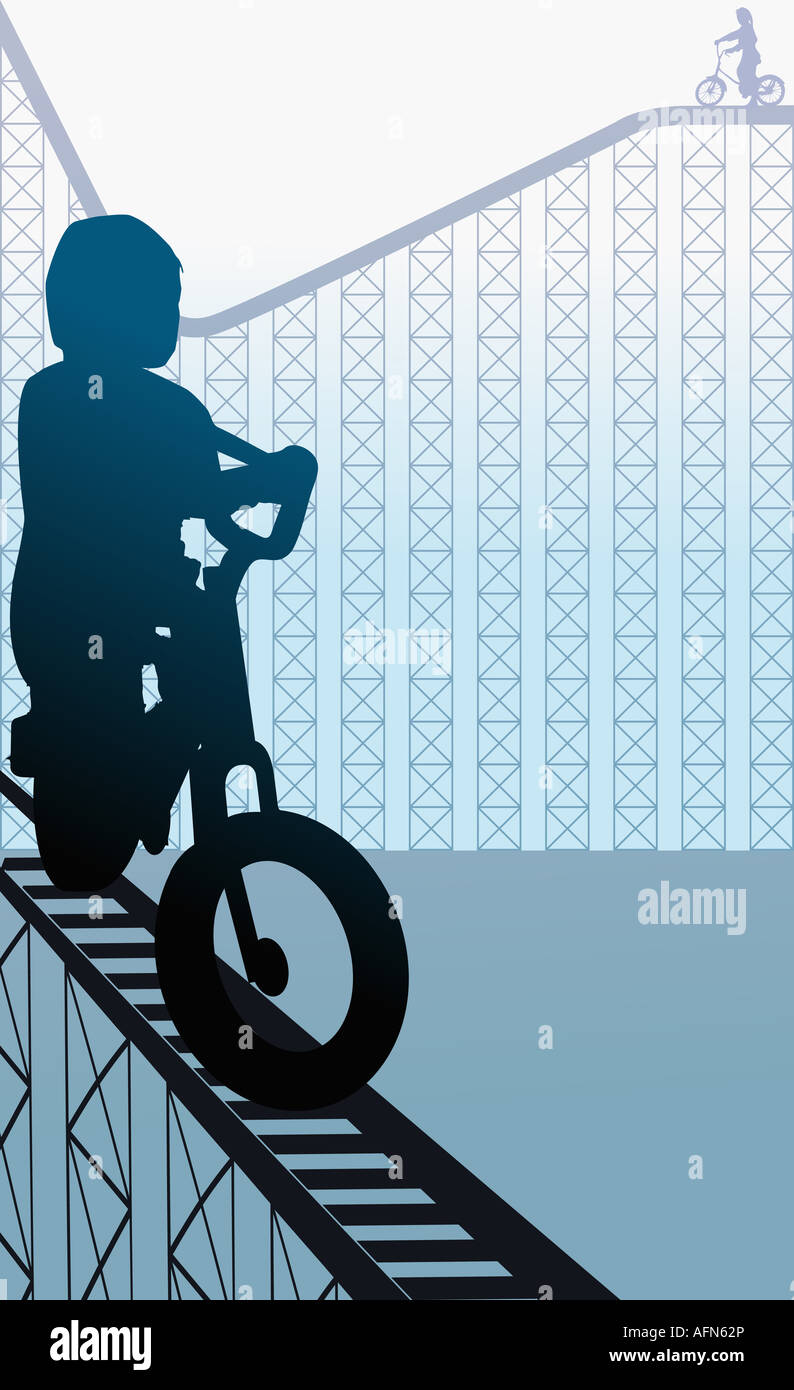 Boy riding a bicycle at an amusement park Stock Photo - Alamy