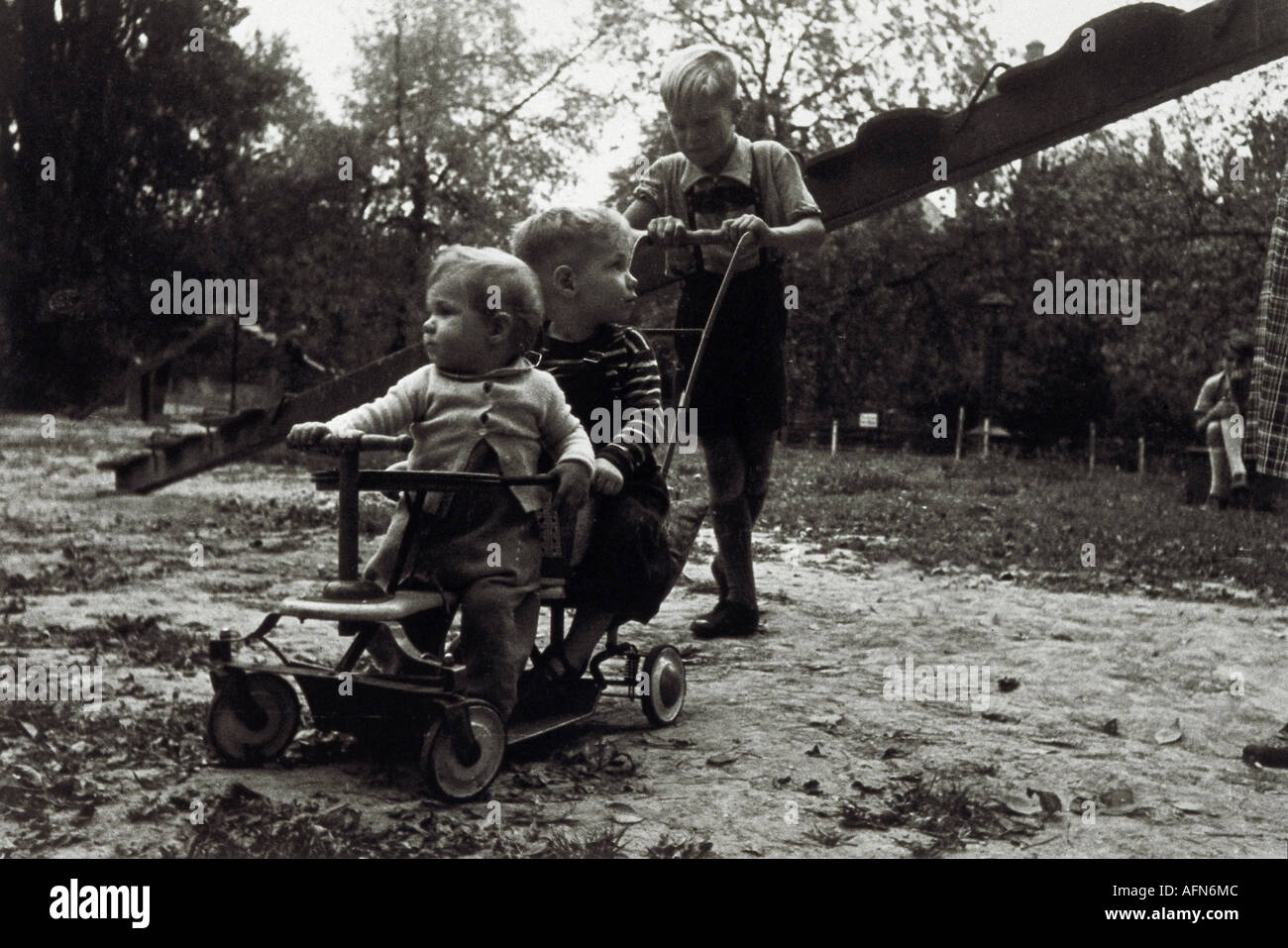 people, children, three boy at the playground, Germany, 1948, cart ...