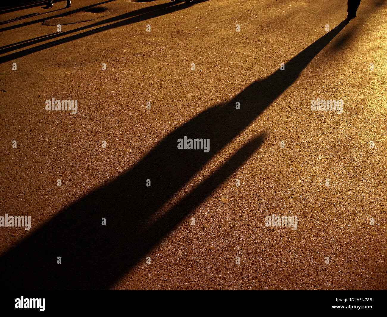 people on the street shadow late afternoon Stock Photo - Alamy