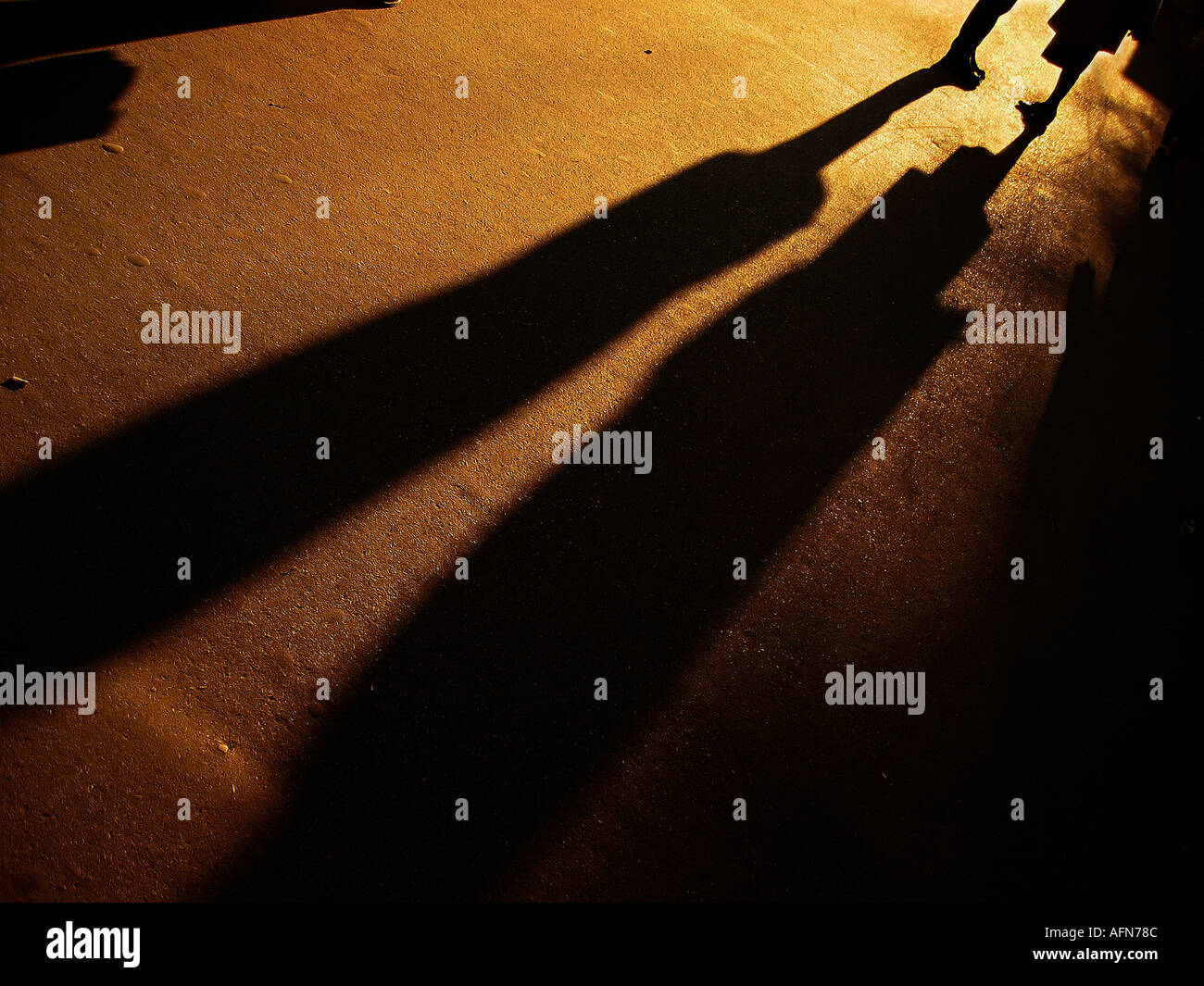 people on the street shadow late afternoon Stock Photo - Alamy