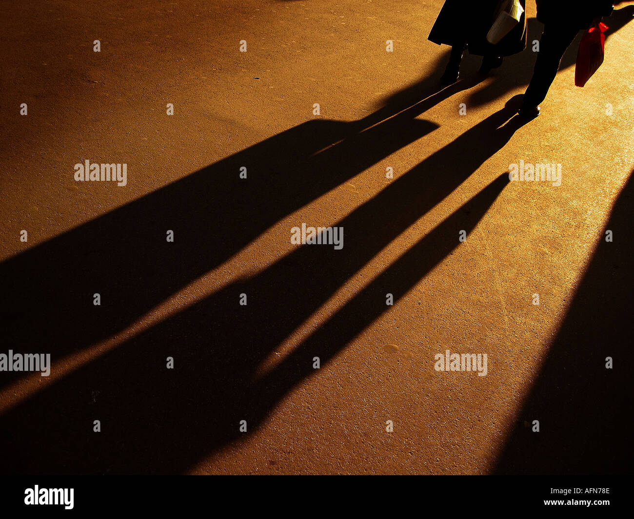 people on the street shadow late afternoon Stock Photo - Alamy