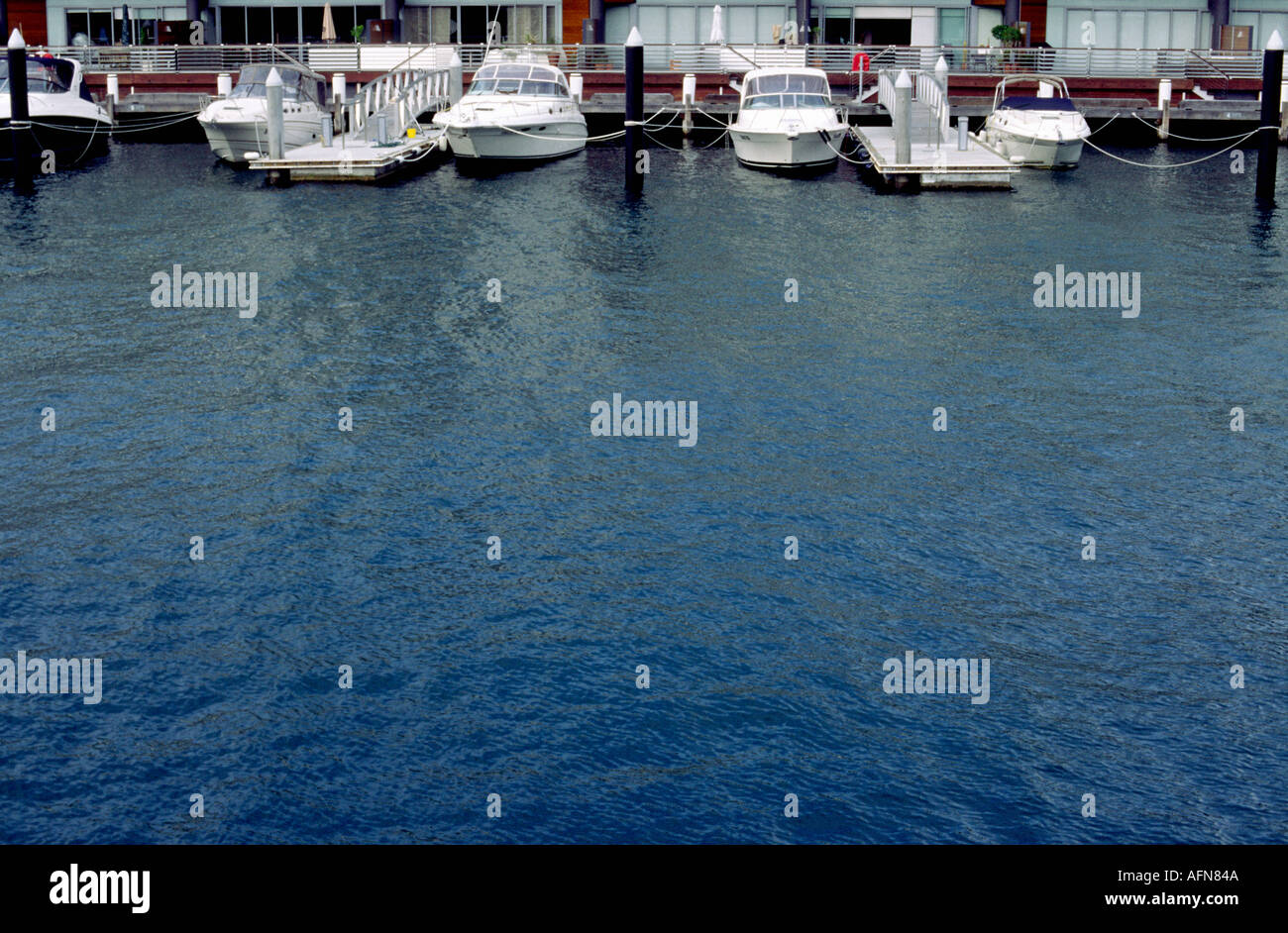Private jetty wharf with light and medium sized sail and power boats on ...