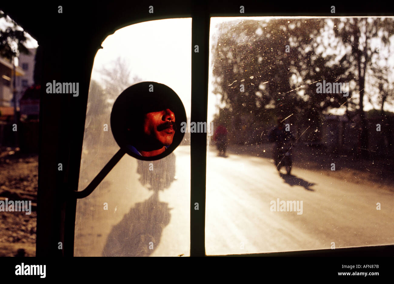 Inside an auto rickshaw in India looking through the front driver ...