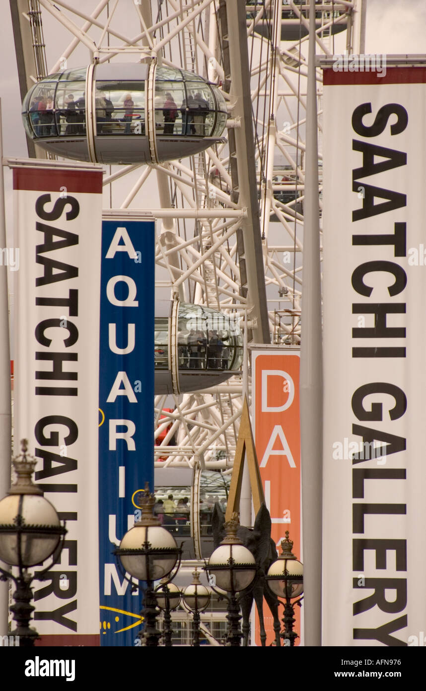View of the London Eye through advertising banners on the Thames ...