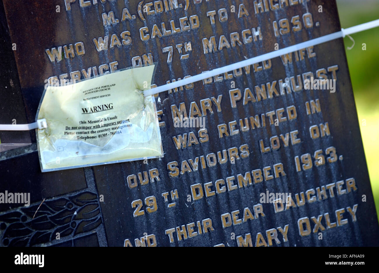 Unsafe warning notice on gravestone Stock Photo - Alamy