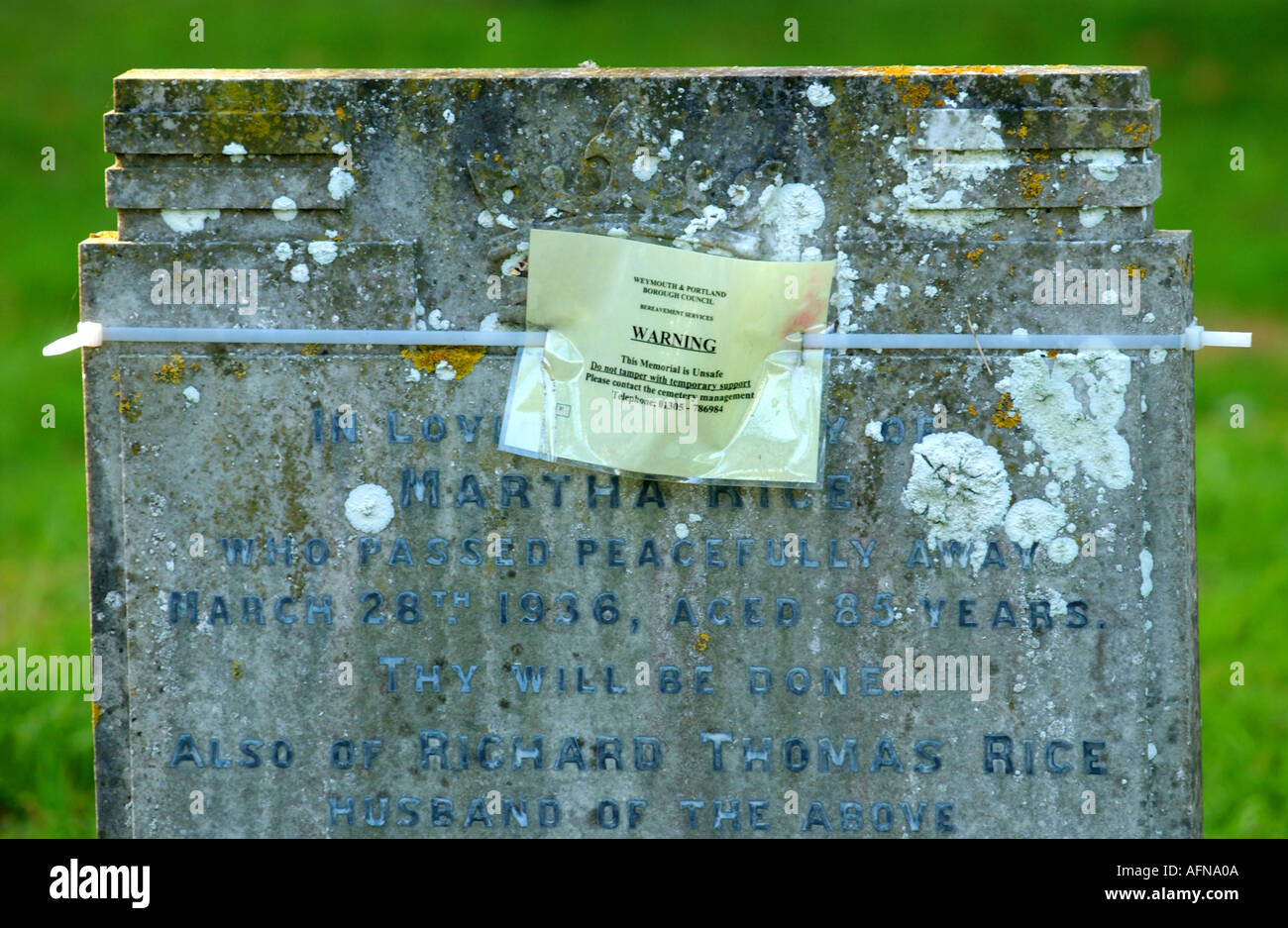 Unsafe warning notice on gravestone Stock Photo - Alamy