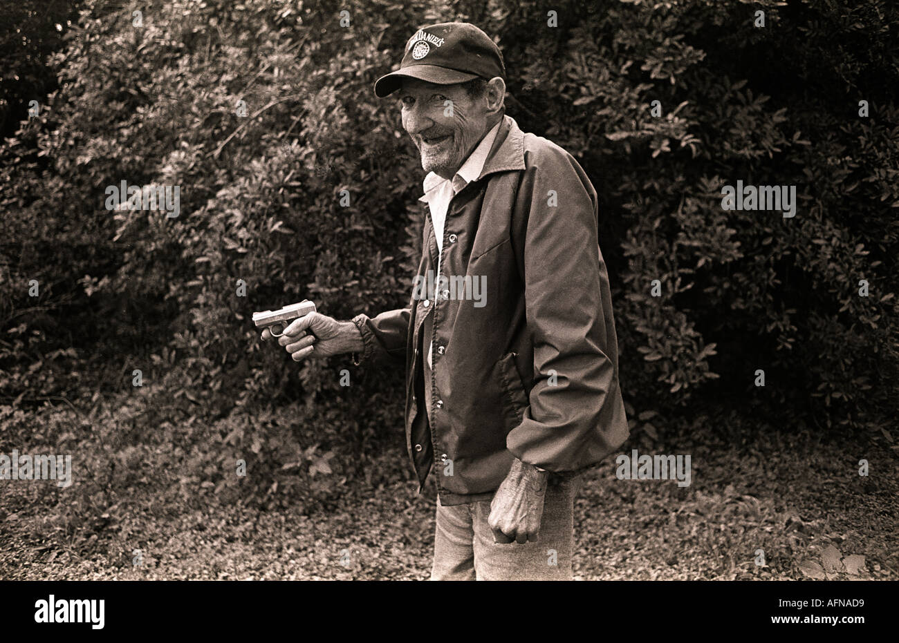 An old hobo hold smiles as he show off the pistol he used to travel ...