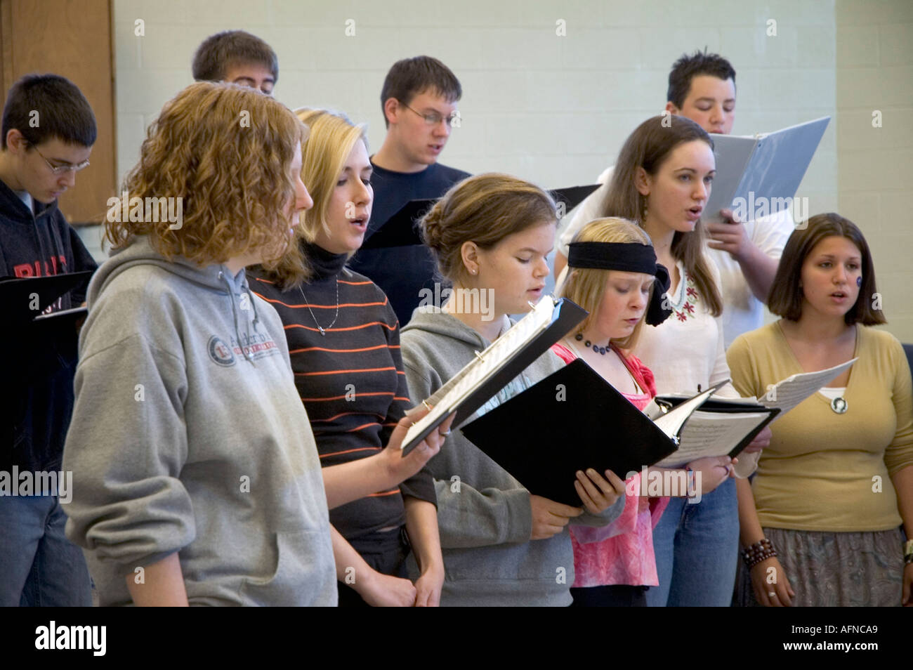 Teacher directs music choir as students prepare for a performance Stock ...