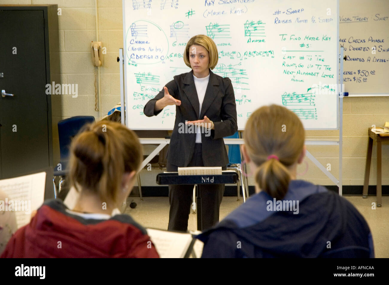 Teacher directs music choir as students prepare for a performance Stock ...
