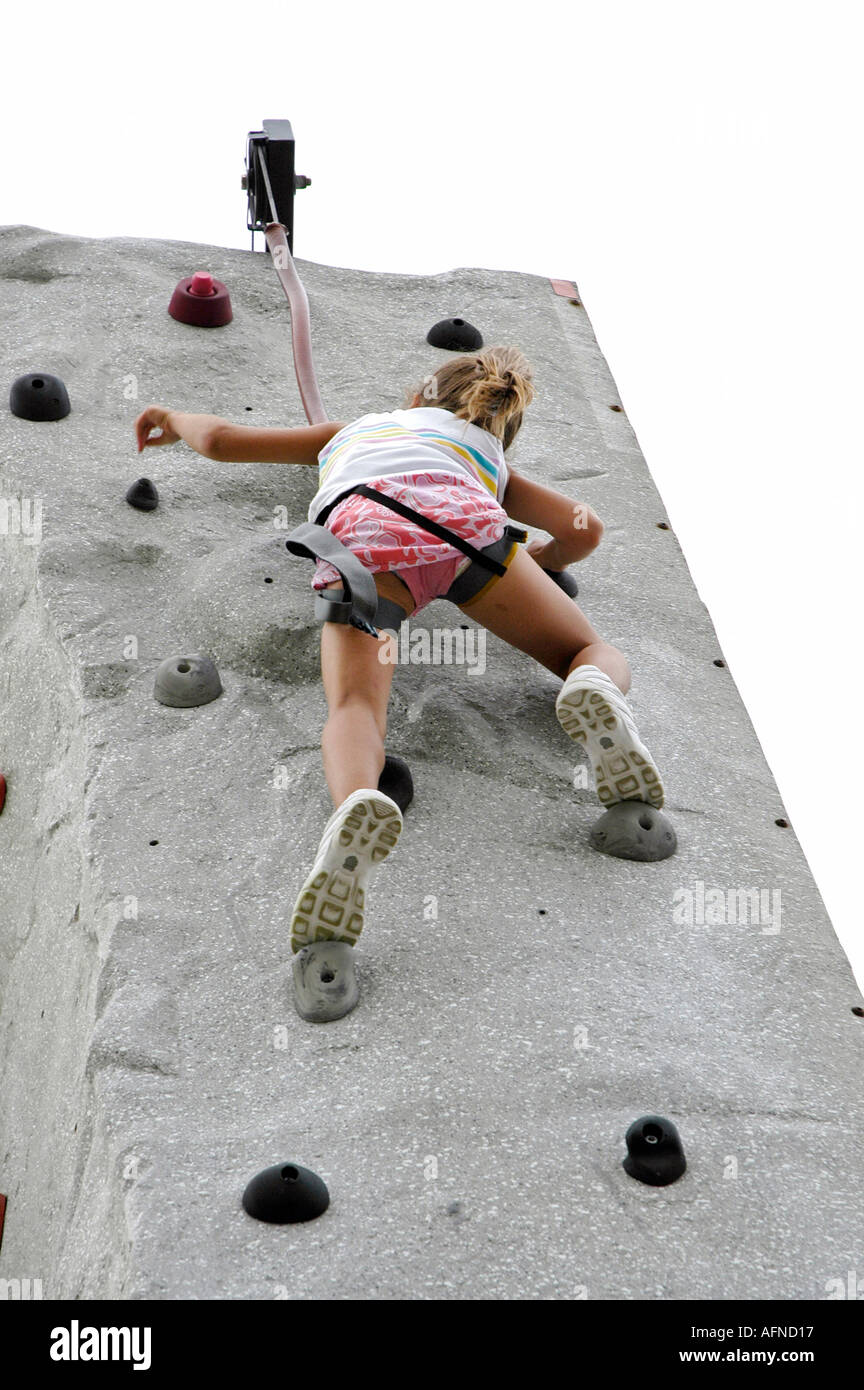 Female climbs a rock wall for recreation Stock Photo - Alamy