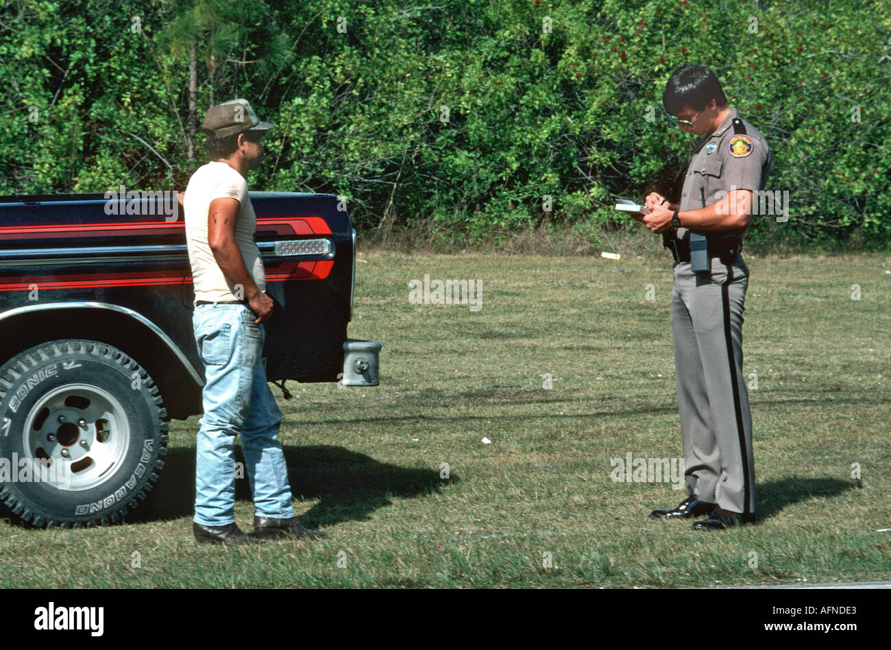 Hispanic Florida state police officer write a traffic moving violation ...