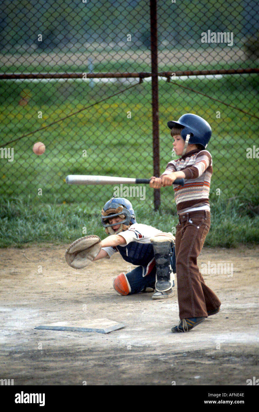 Baseball Softball Action Little league batter hits ball Stock Photo - Alamy