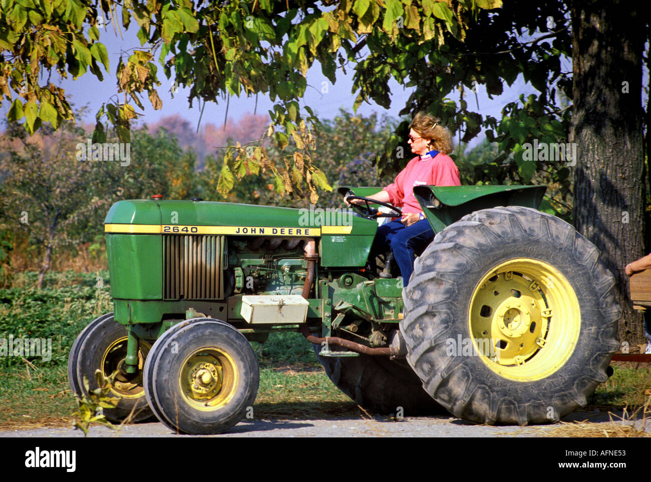 Female farmer drive a tractor Stock Photo - Alamy