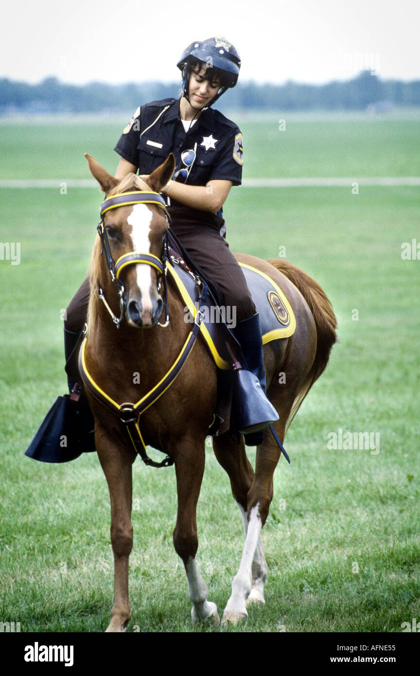 Female sheriff deputy riding on a horse Stock Photo - Alamy