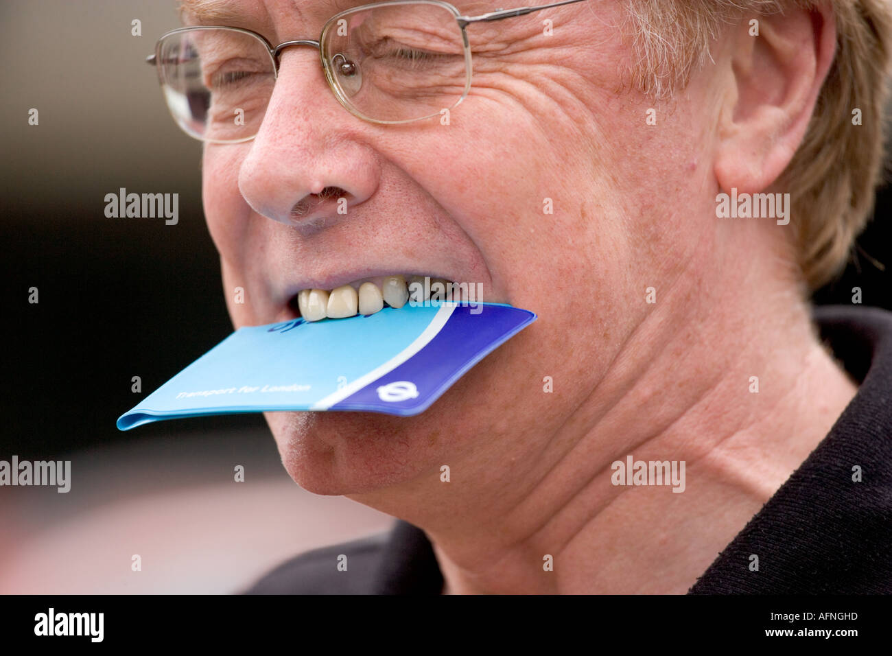 Man biting his oyster card Stock Photo - Alamy