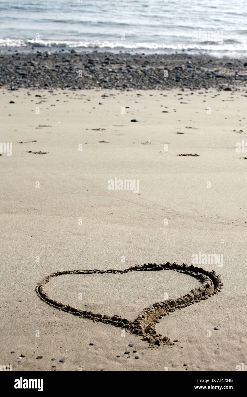 Heart shape in the sand Stock Photo - Alamy