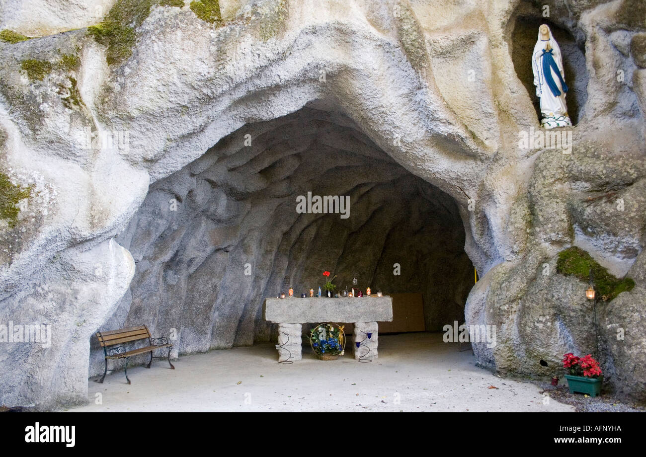Cave grotto with religious symbols and altar Stock Photo - Alamy