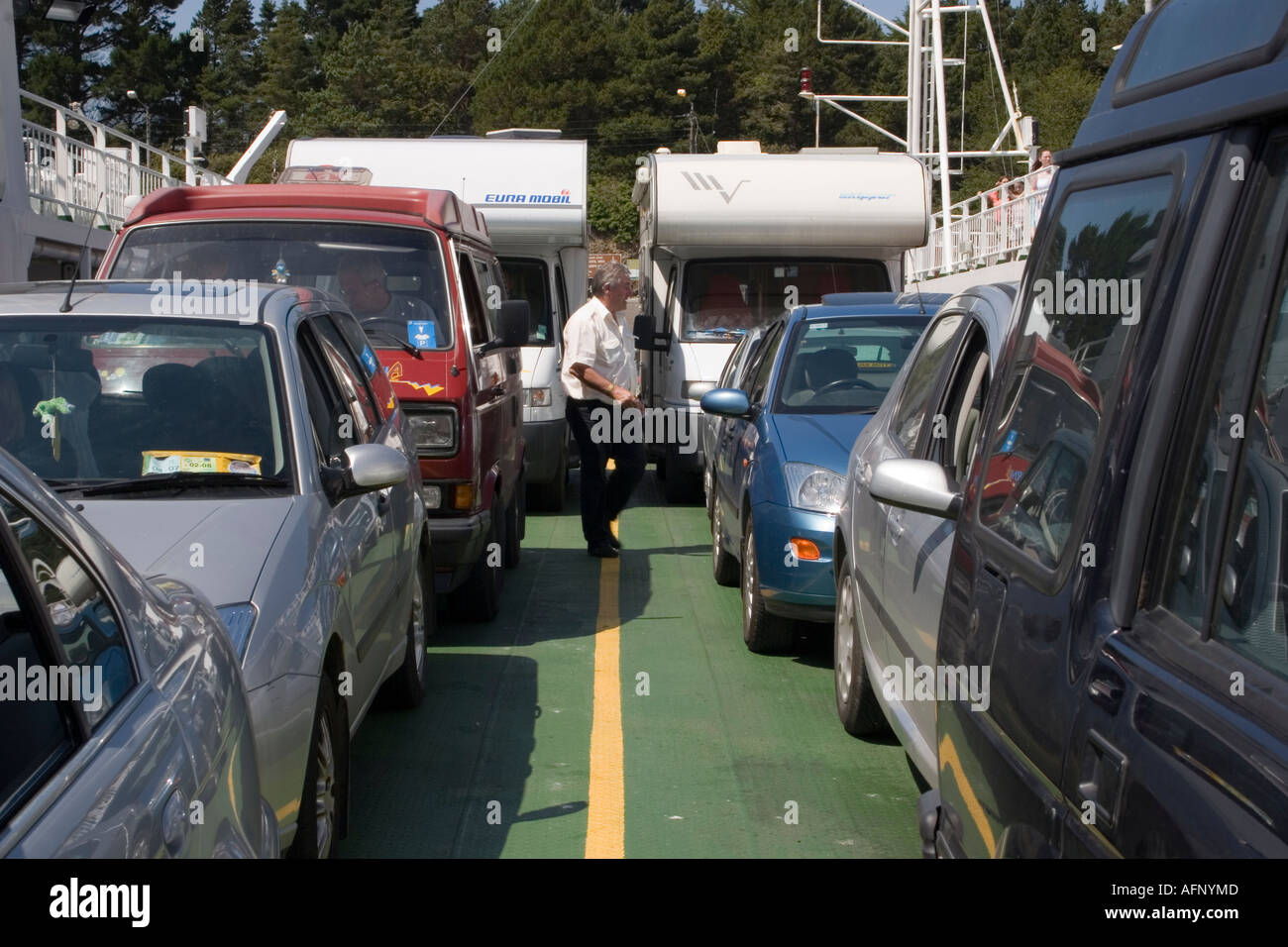 Cars lorries trucks and other road vehicles on car ferry Tarbert county ...
