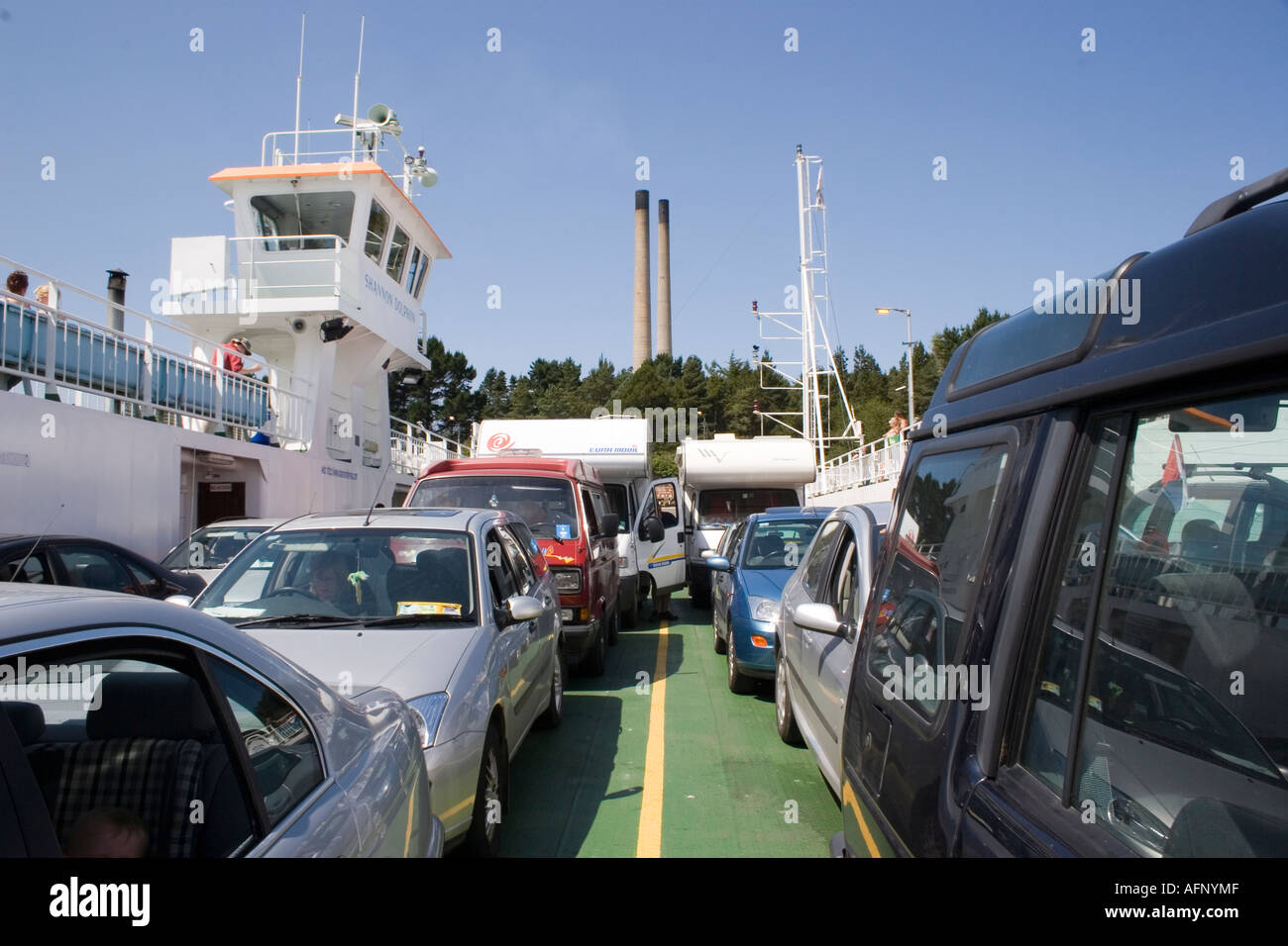 Cars lorries trucks and other road vehicles on car ferry Tarbert county ...