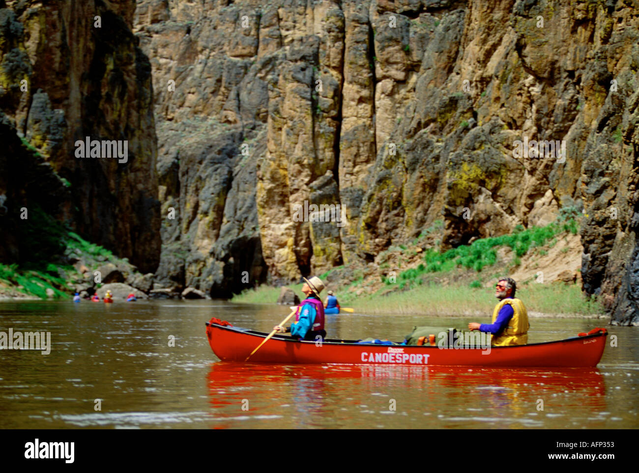 USA Idaho- Oregon East Fork of the Owyhee River paddlers in red canoe ...