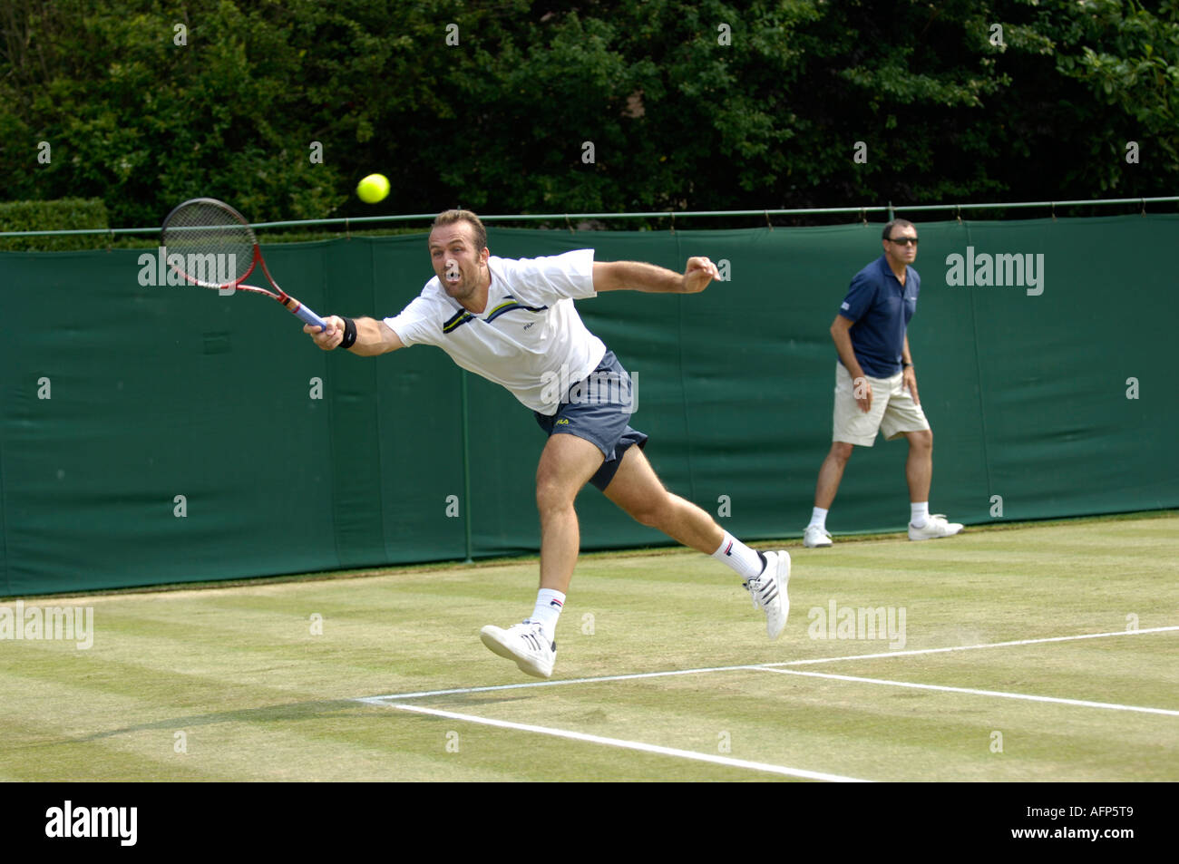 Anthony Dupuis strains to return forehand Stock Photo - Alamy