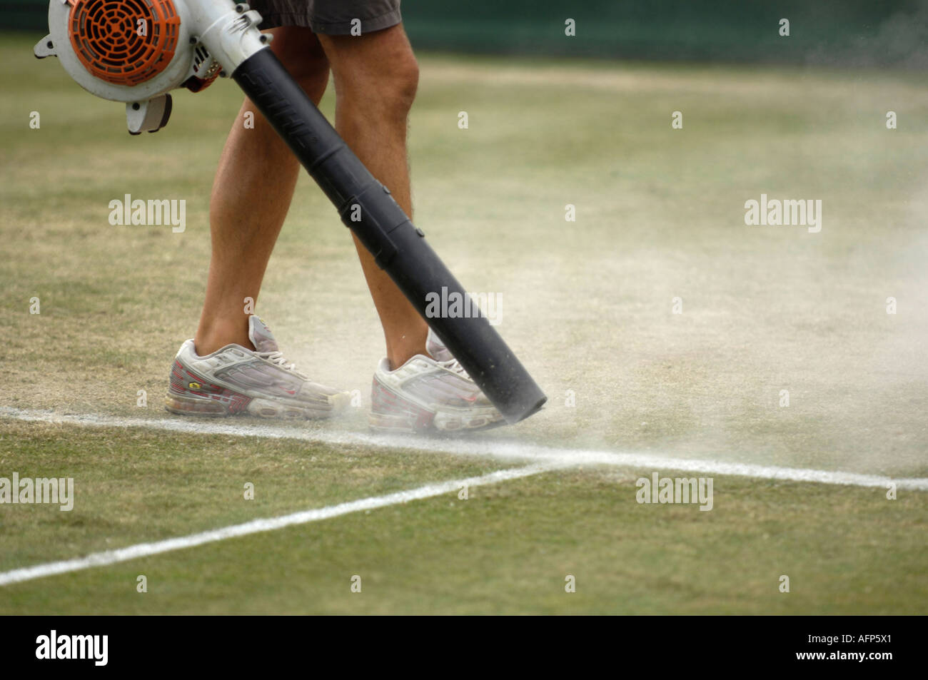 Clearing dust from the line on a tennis court Stock Photo - Alamy