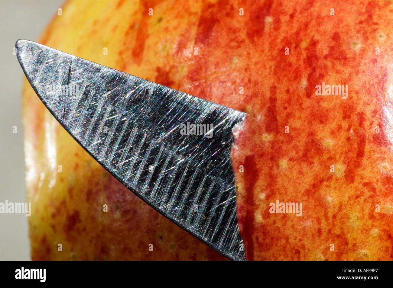 Knife cutting through an apple Stock Photo - Alamy