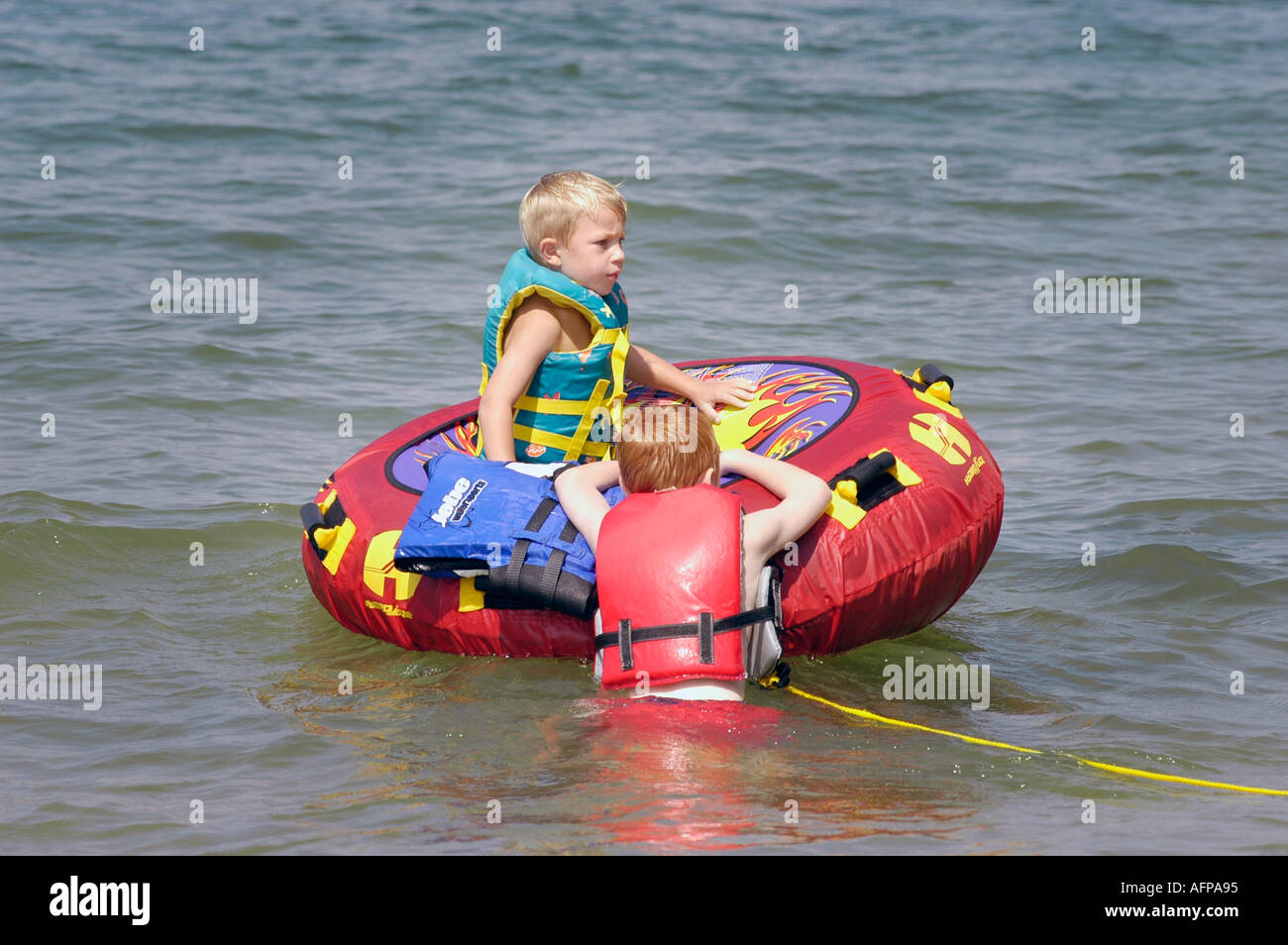 Kids with their inflatable boat at the lake Stock Photo - Alamy