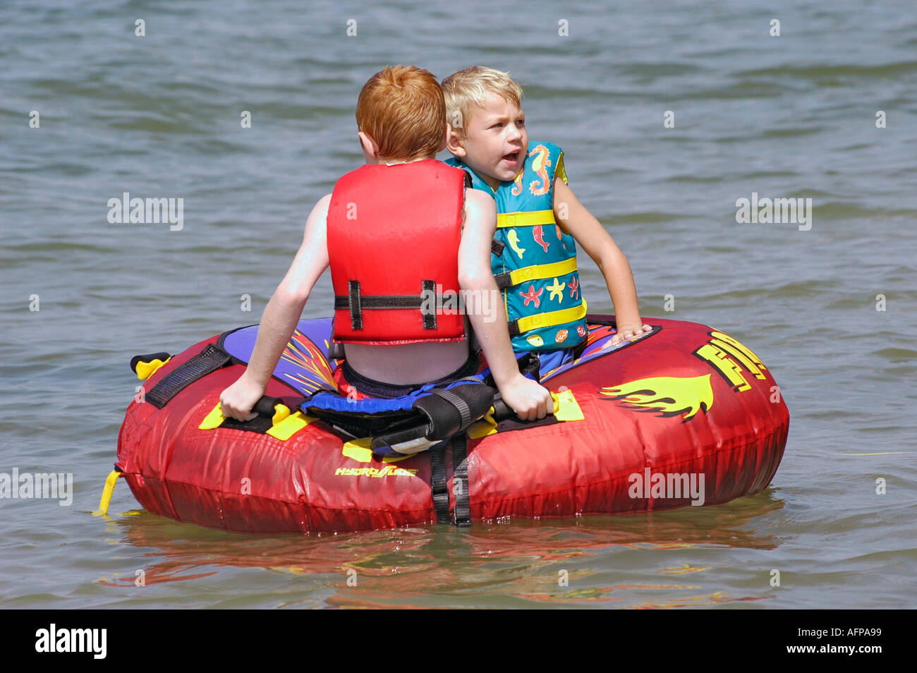 Kids with their inflatable boat at the lake Stock Photo - Alamy