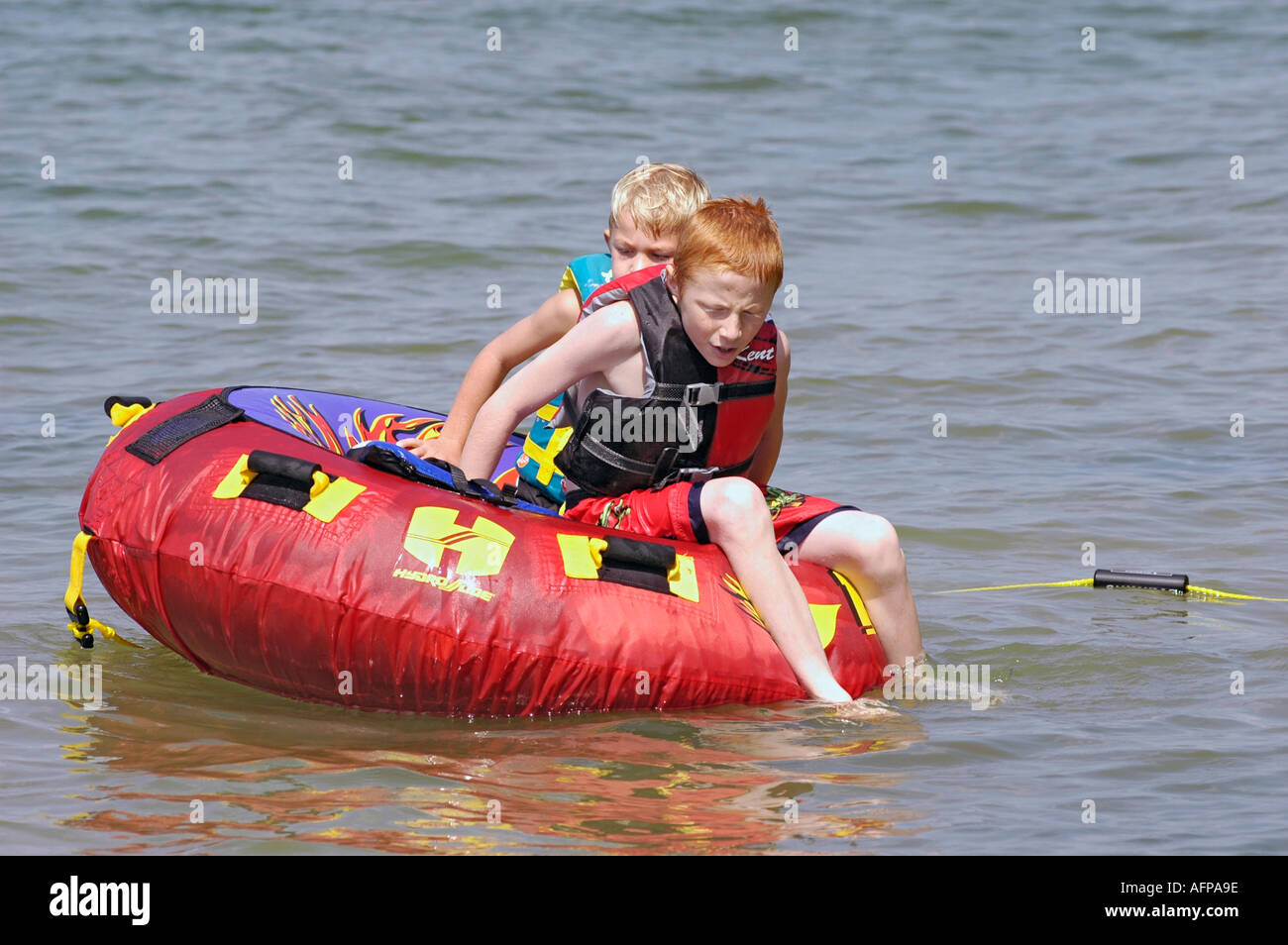 Kids with their inflatable boat at the lake Stock Photo - Alamy